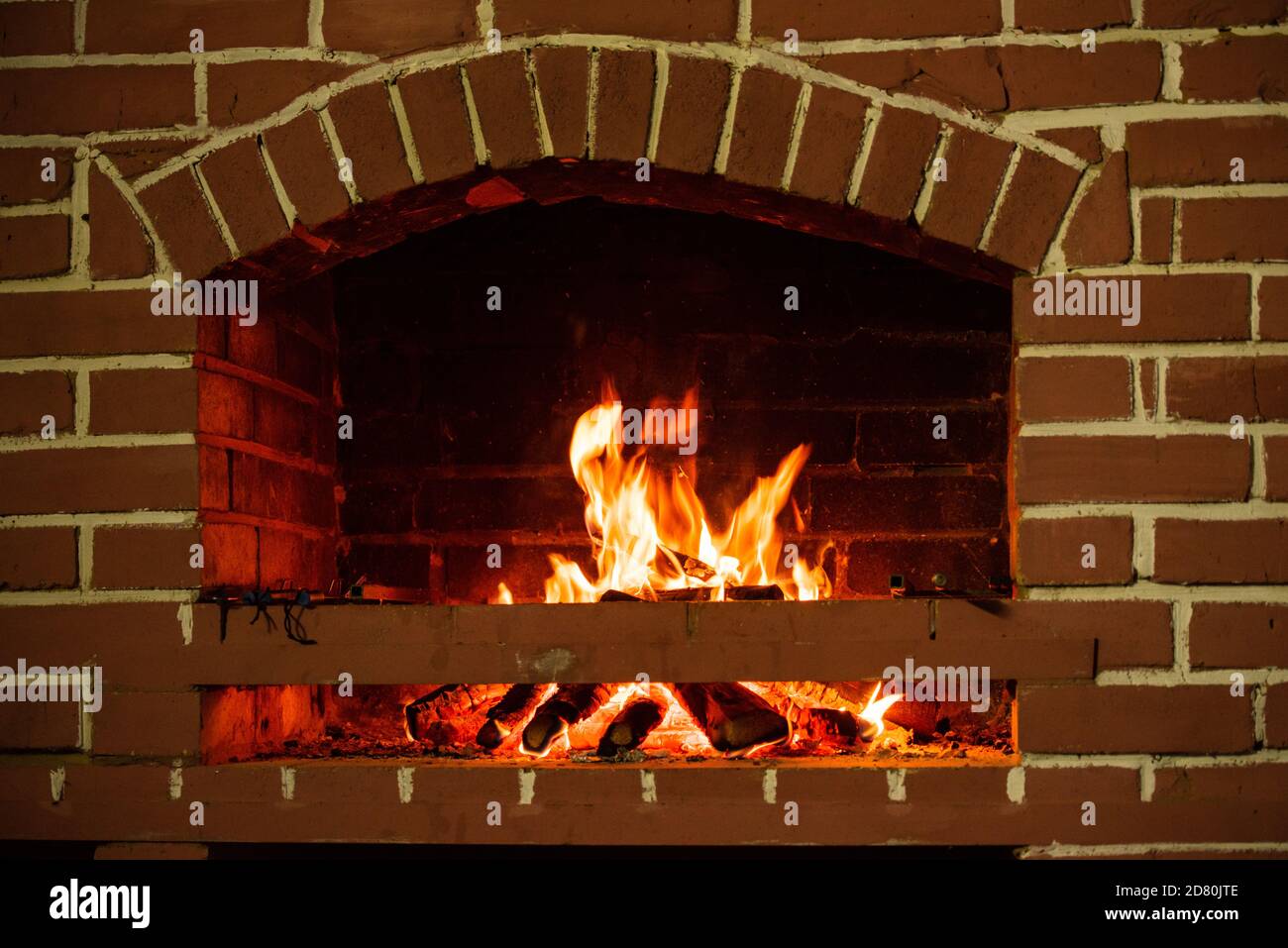 Fire burns in brick fireplace hi-res stock photography and images - Alamy