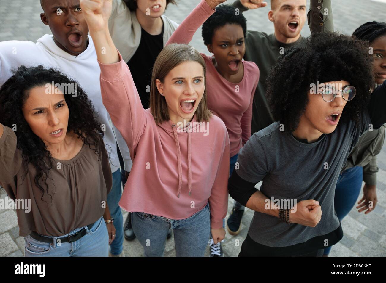 Students yelling slogans and showing fists during demonstration, top ...