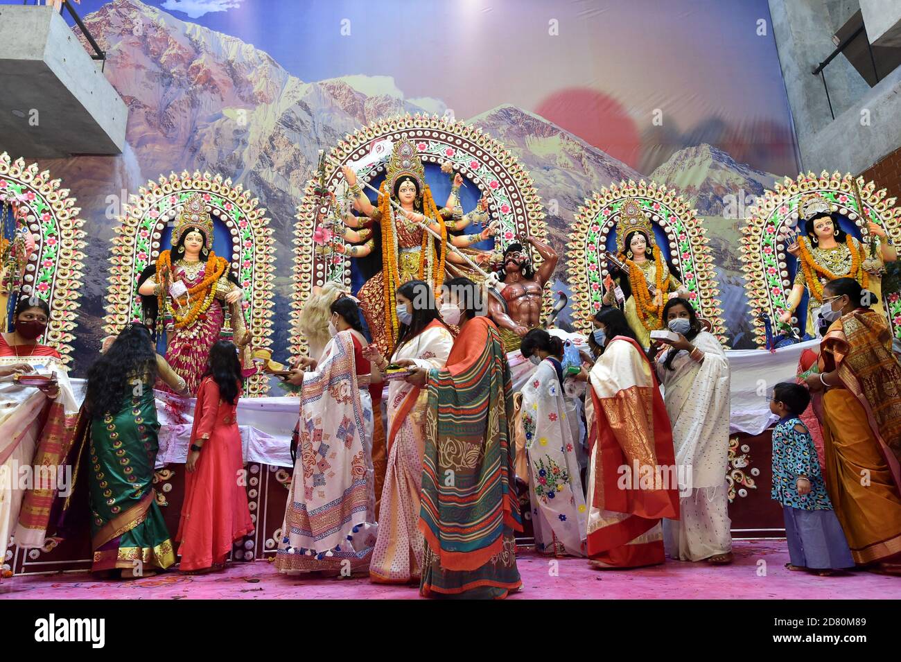 Dhaka. 26th Oct, 2020. Hindu devotees wearing face masks celebrate ...