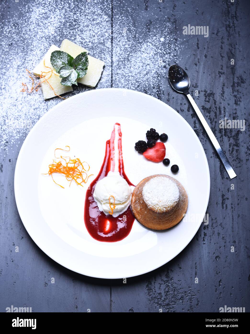 Dessert served with orange noodles in cafe or bakery. Molten lava cake ...