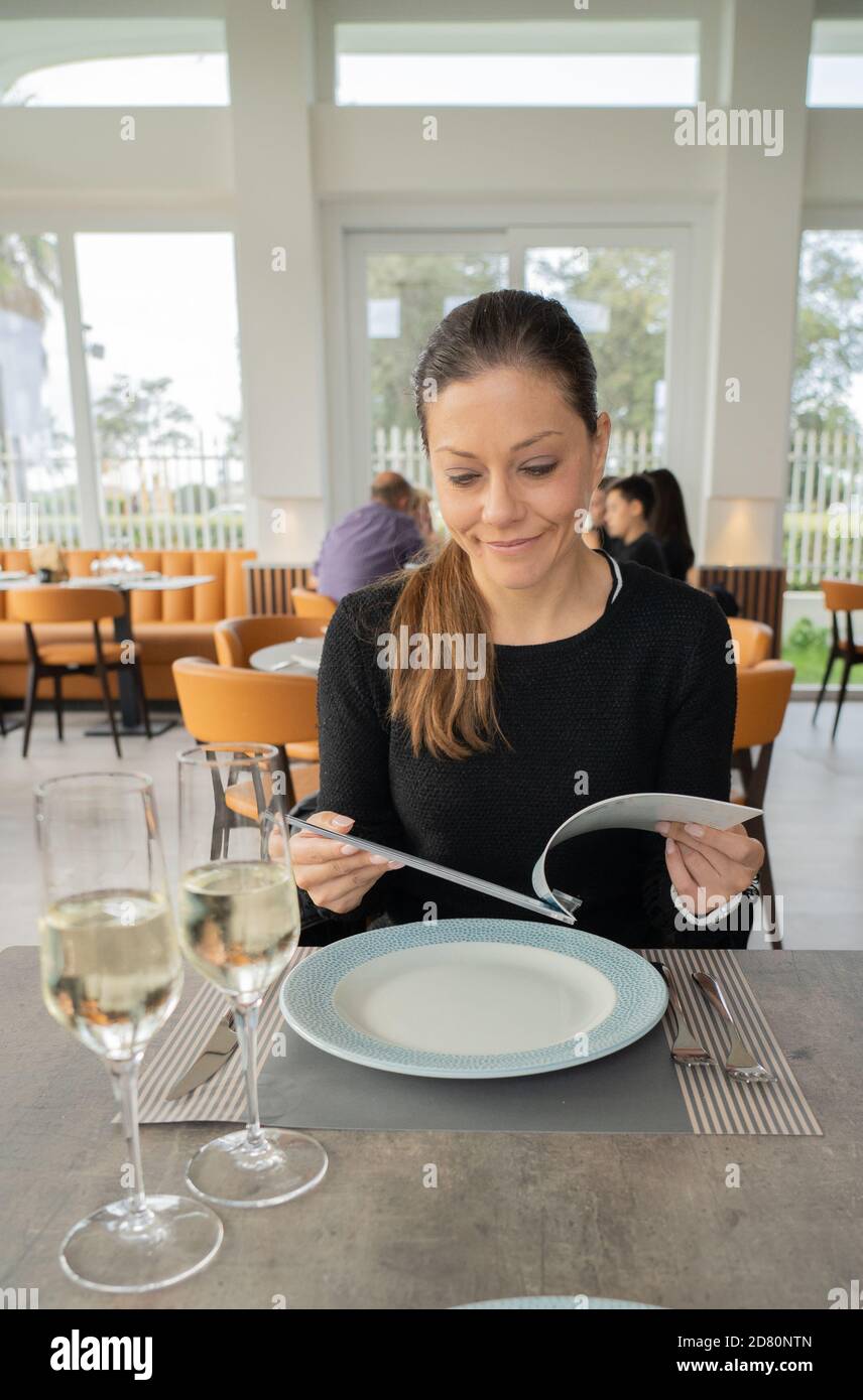 woman reading the menu in restaurant Stock Photo - Alamy