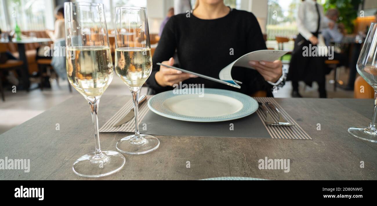 woman reading the menu in restaurant Stock Photo - Alamy