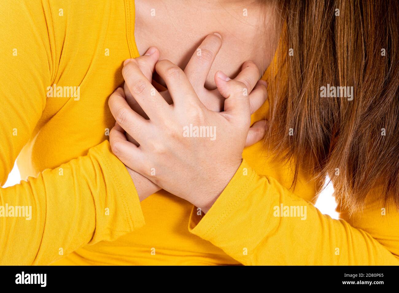 Woman touching her heart or chest isolated white background. Healthcare ...