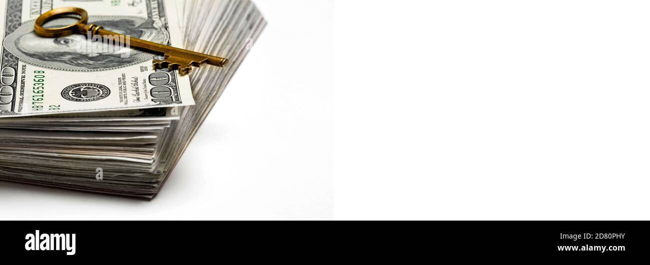 Wealth and riches represented by cash money and a key Stock Photo - Alamy