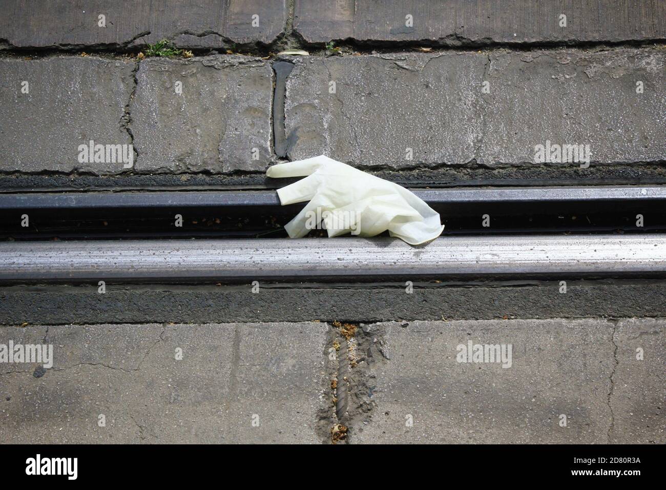 A plastic glove thrown on the ground Stock Photo - Alamy