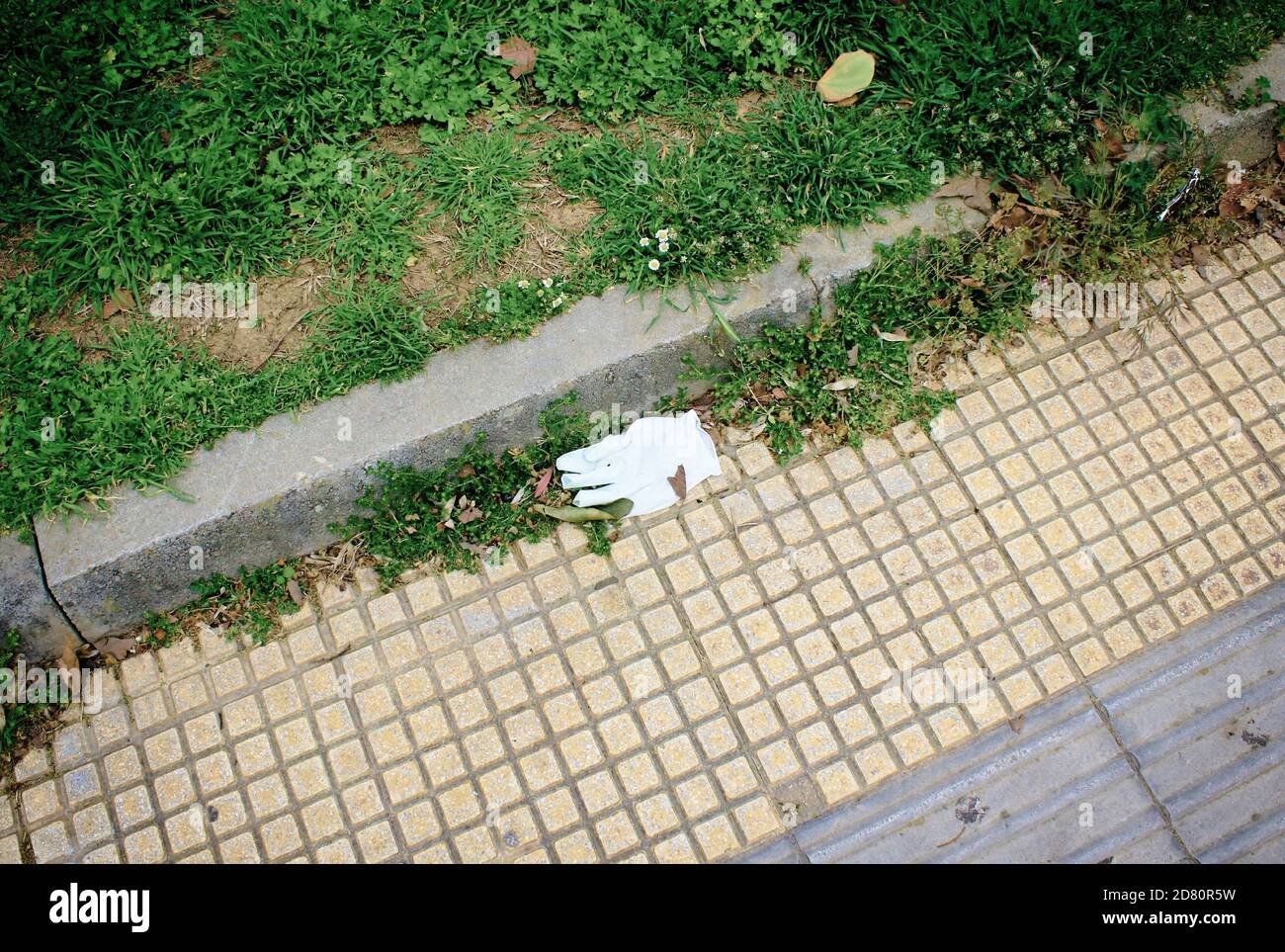 A plastic glove thrown on the ground Stock Photo - Alamy