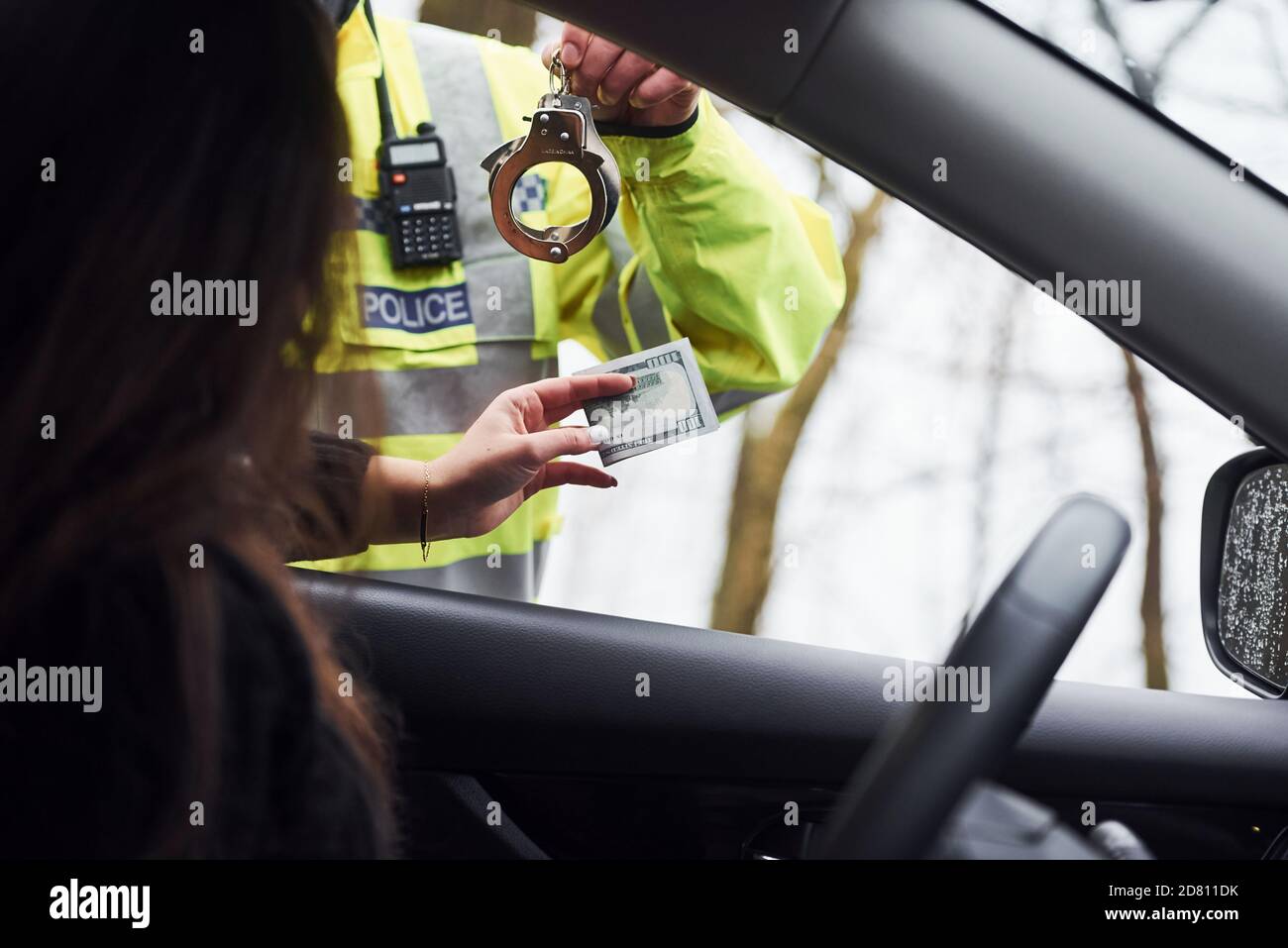 Male police officer in green uniform and with handcuffs refuse to take ...