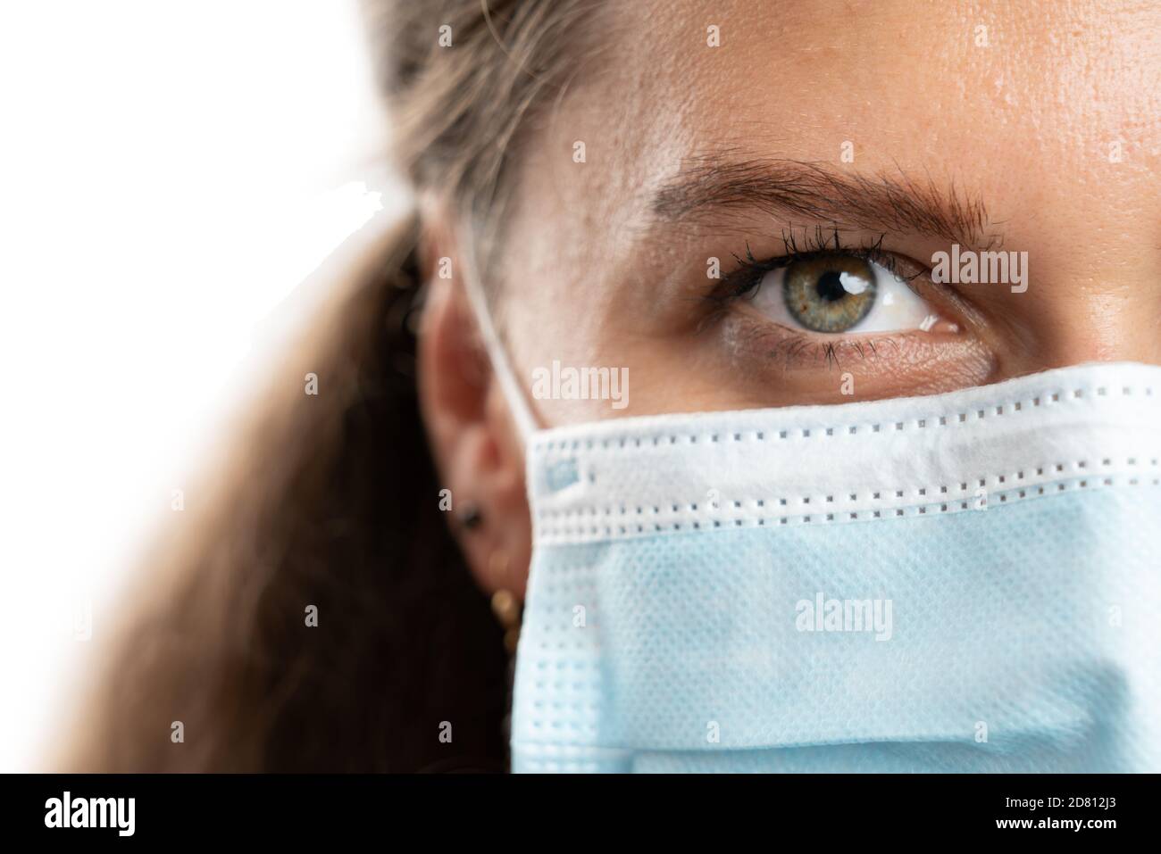 Close-up of adult female model half face wearing medical or surgical ...