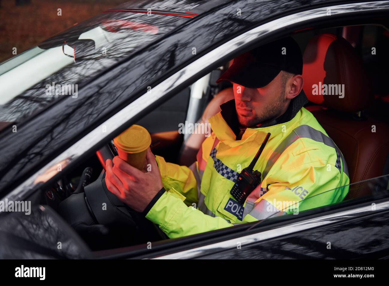 Male police officer sitting in hi-res stock photography and images - Alamy