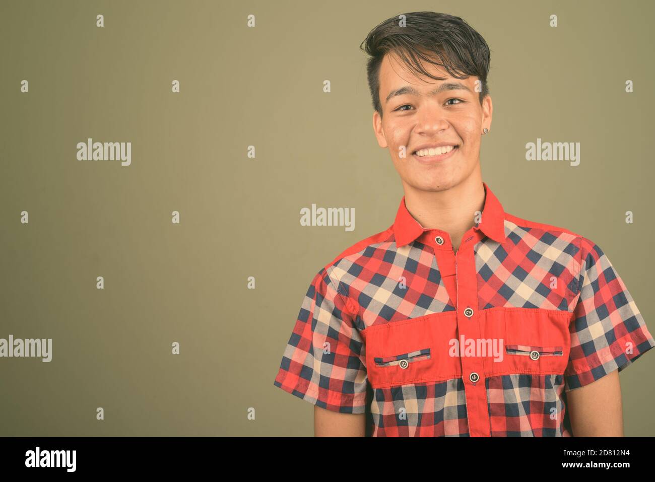 Young handsome Indian man against colored background Stock Photo - Alamy