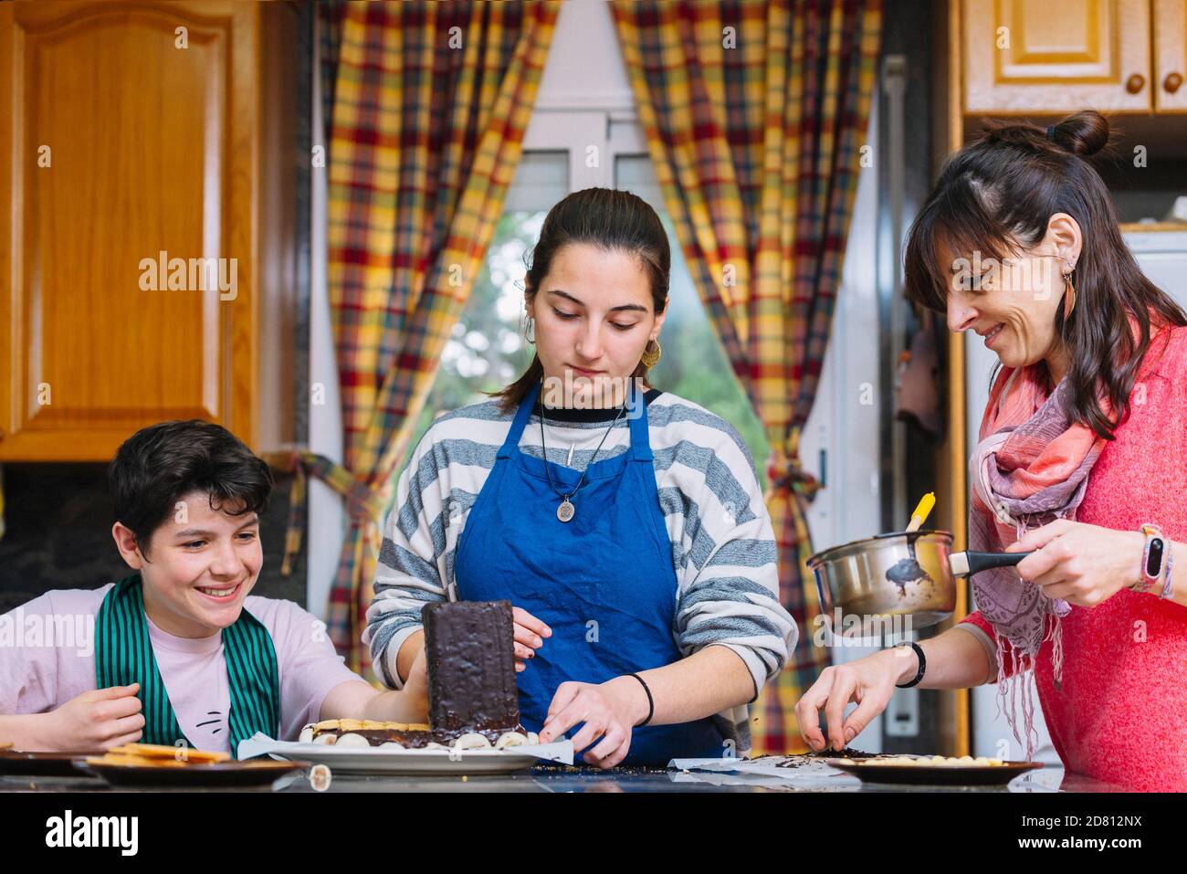 Family funny making chocolate cake at the kitchen Stock Photo - Alamy