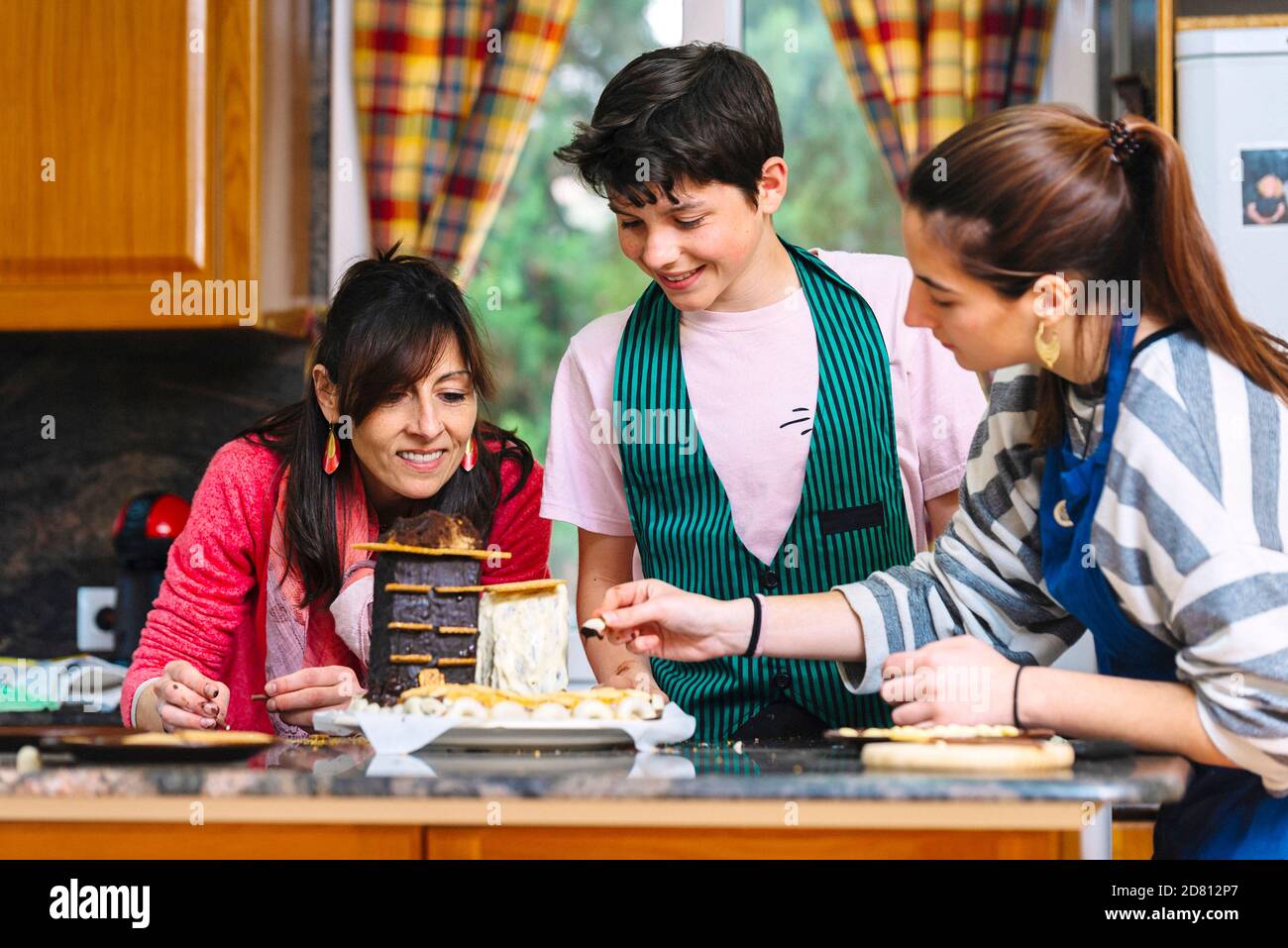 Family funny making chocolate cake at the kitchen Stock Photo - Alamy