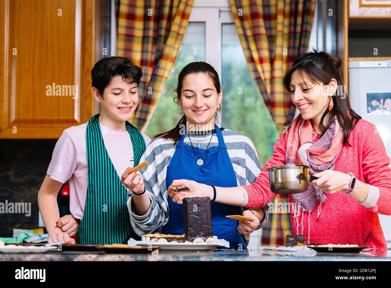 Family funny making chocolate cake at the kitchen Stock Photo - Alamy