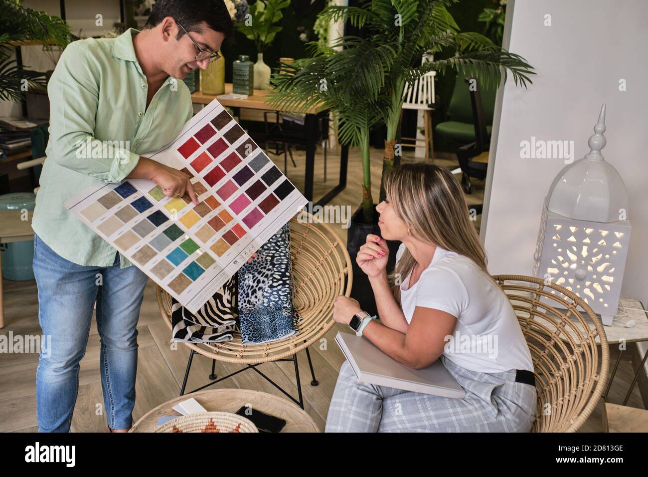 fabric salesman shows the color chart to his customer Stock Photo - Alamy