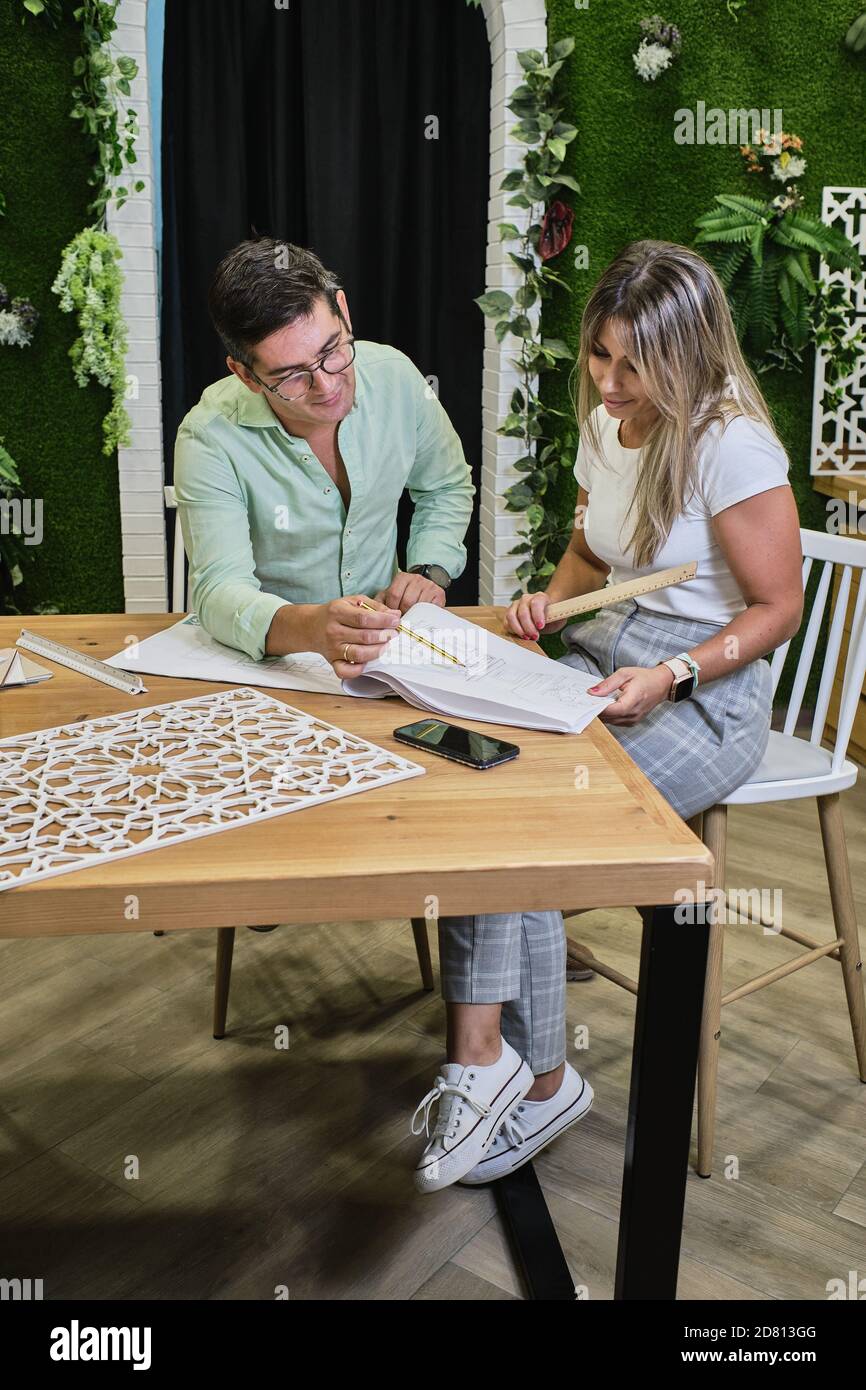 co-workers smile as they prepare a new design for a house Stock Photo ...