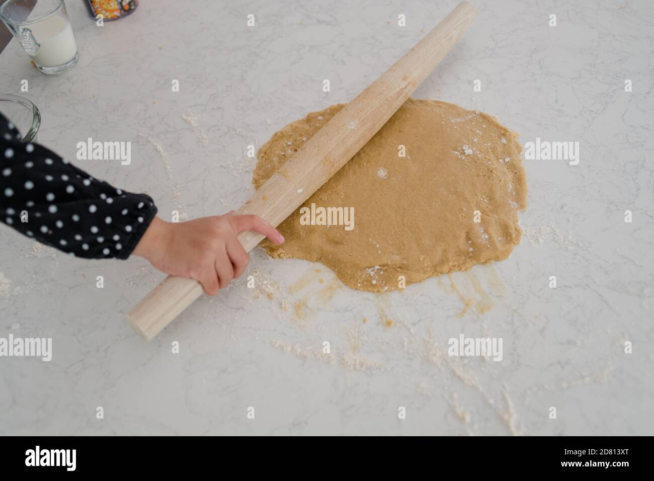 Little girl using rolling pin to roll out cookie dough Stock Photo - Alamy
