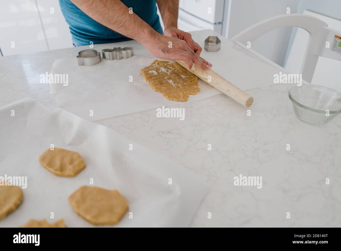 man rolling out cookie dough for halloween cookies Stock Photo - Alamy