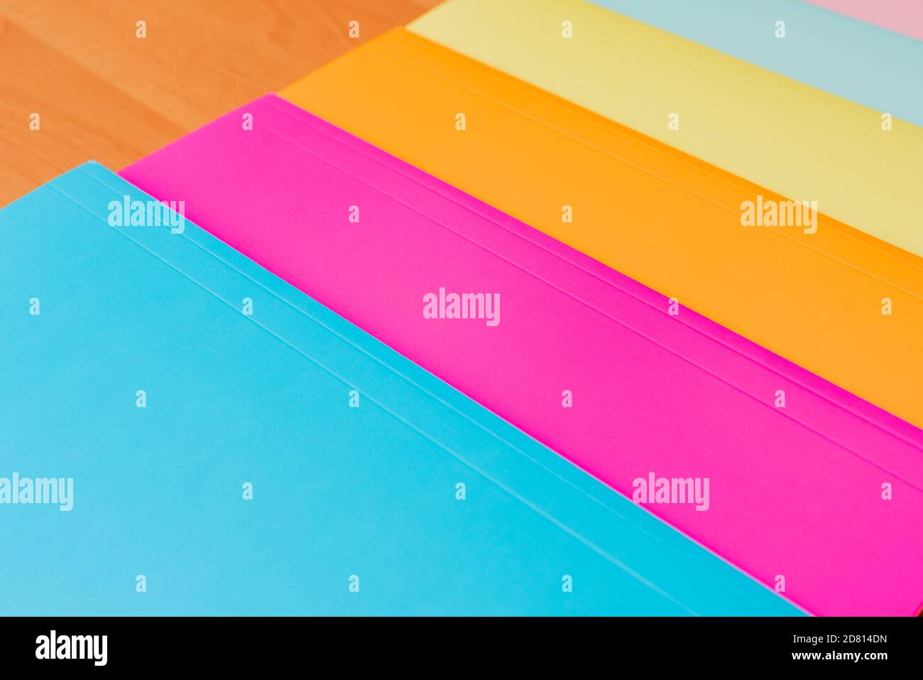 Collection of multi colorful papers lying on the table Stock Photo - Alamy