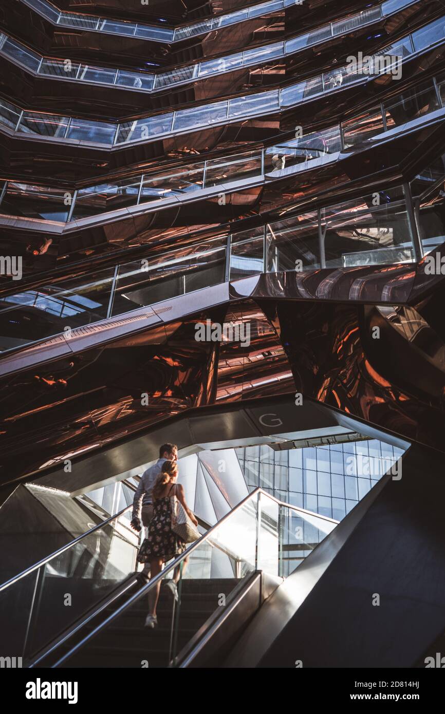 Couple walking into a stunning building with sunlight Stock Photo - Alamy