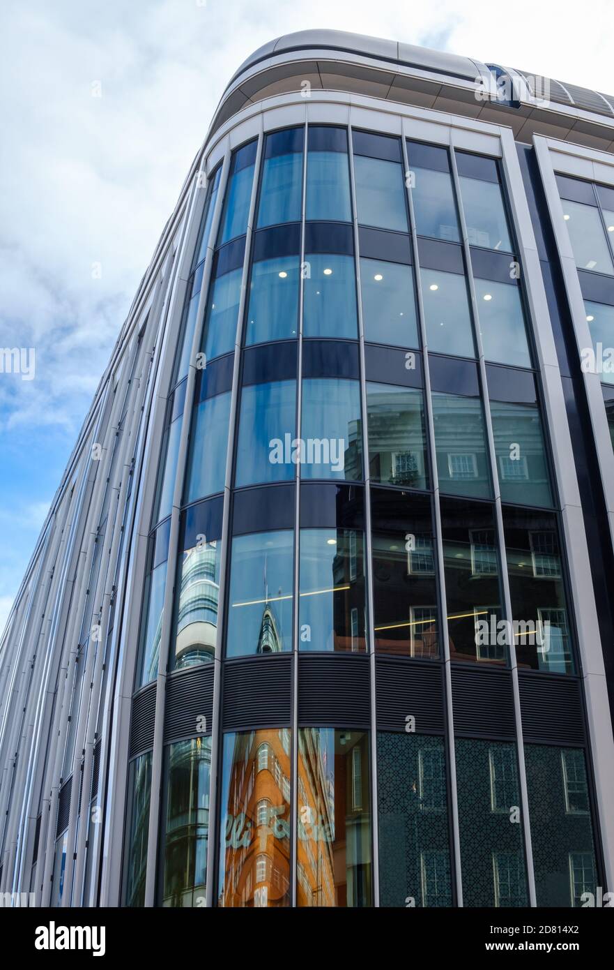 Sun reflecting on the glass walls of Park House a modern, curved mixed ...