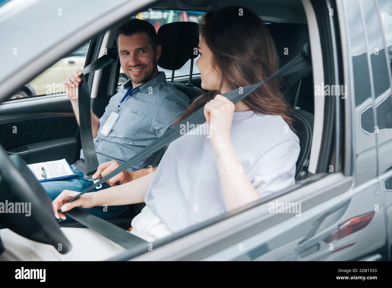 Driving instructor male student fastening hi-res stock photography and ...