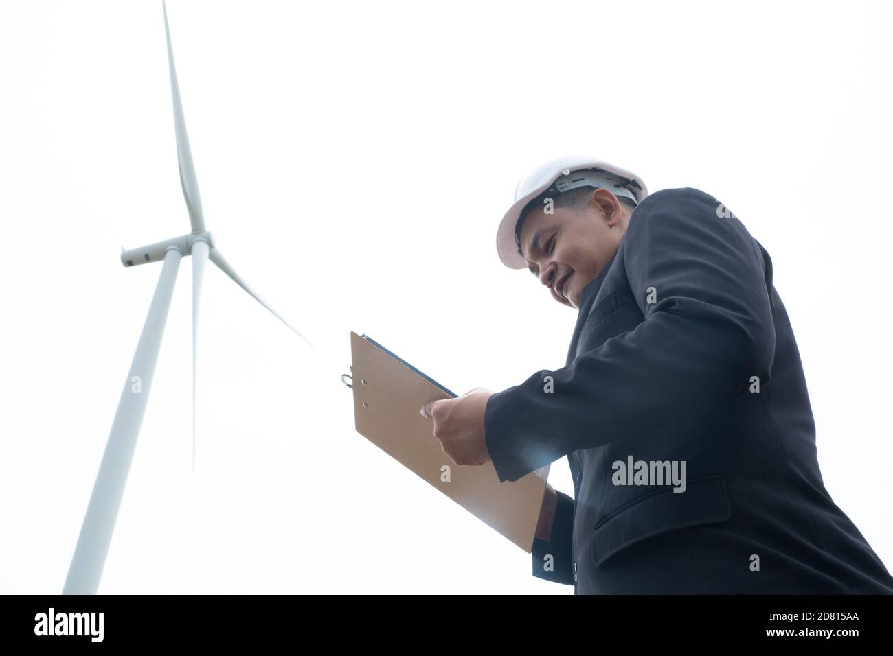 Engineers windmills wearing face mask and working on clipboard against ...