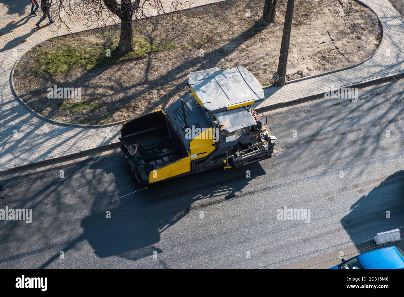 Industrial asphalt paver machine laying fresh asphalt on road ...