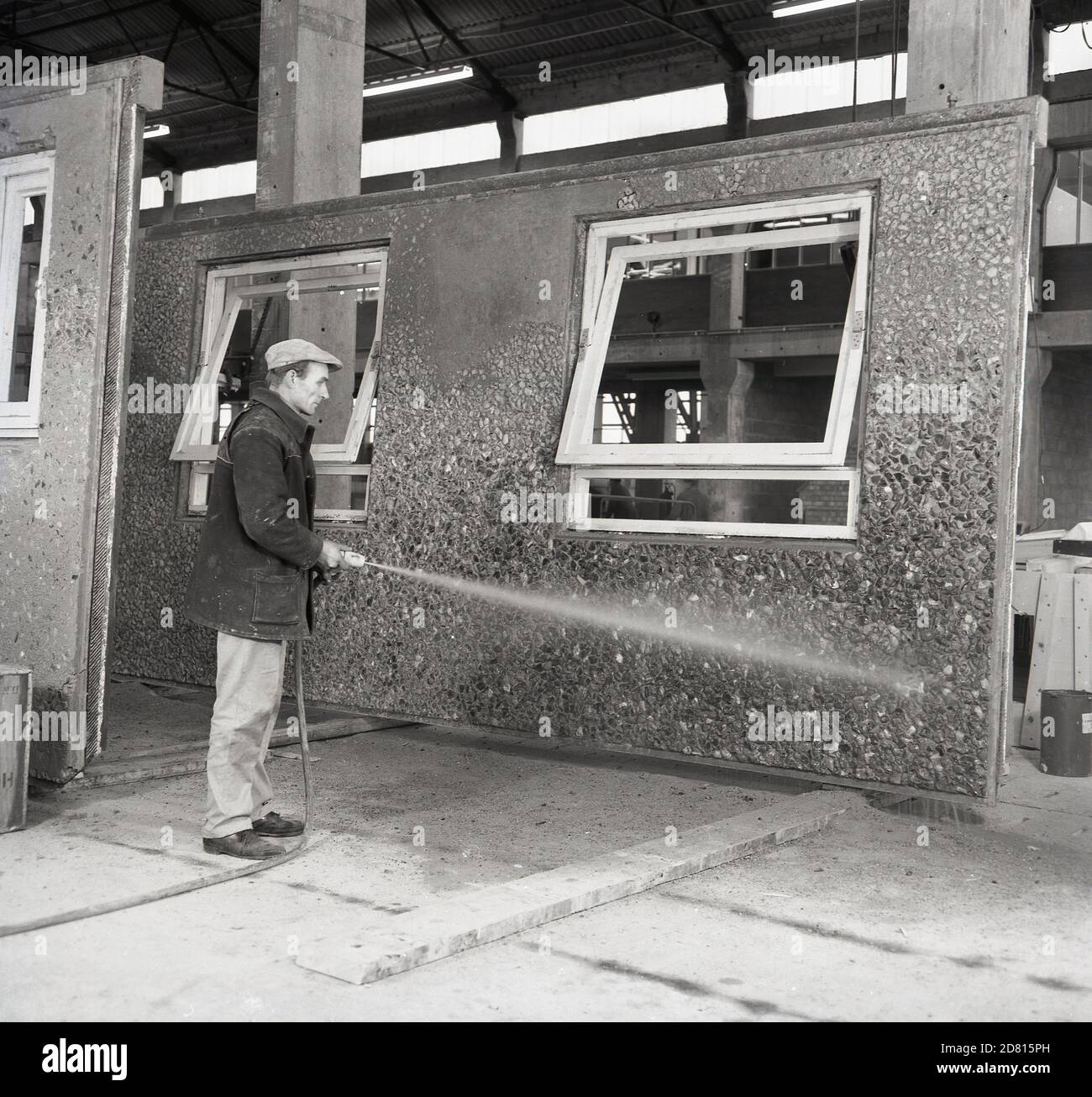 1960s, historical, workman washing down a newly constructed precast ...