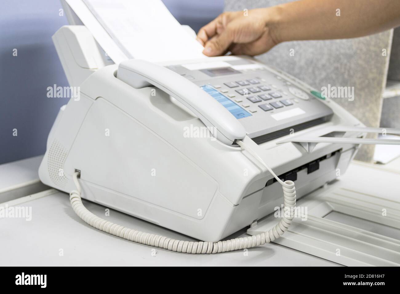 hand man are using a fax machine in the office, equipment for data ...