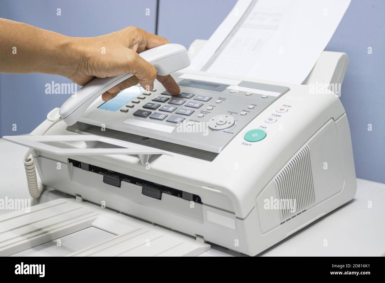 hand man are using a fax machine in the office, equipment for data ...