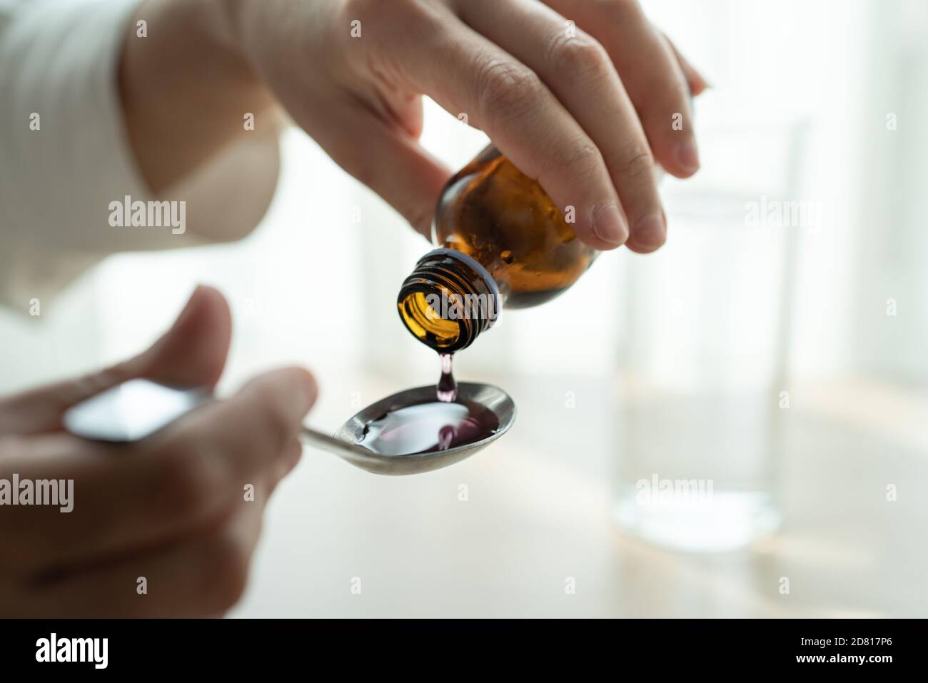 Cough syrup spoon person hi-res stock photography and images - Alamy