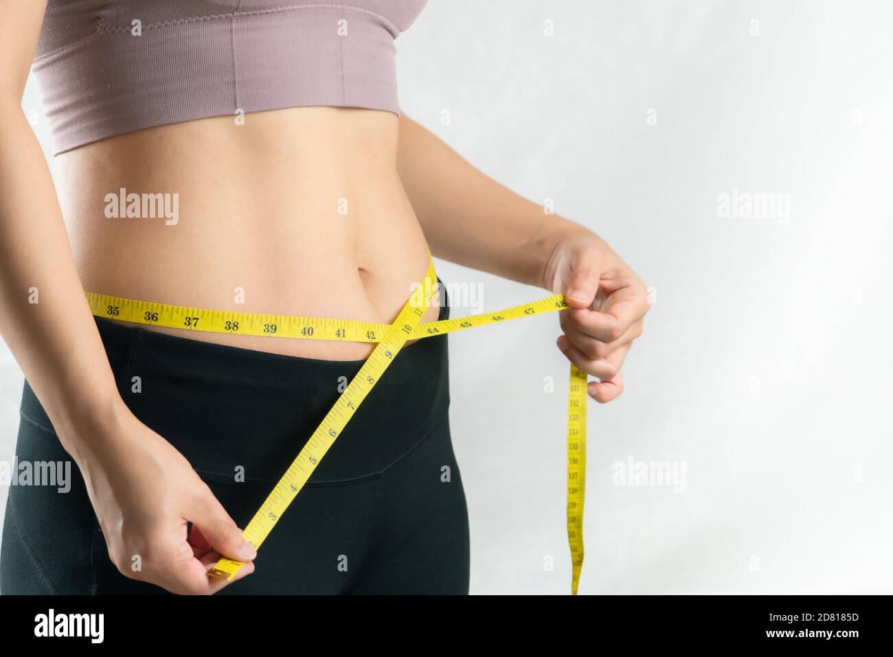 young woman measuring her belly waist with measure tape, woman diet ...