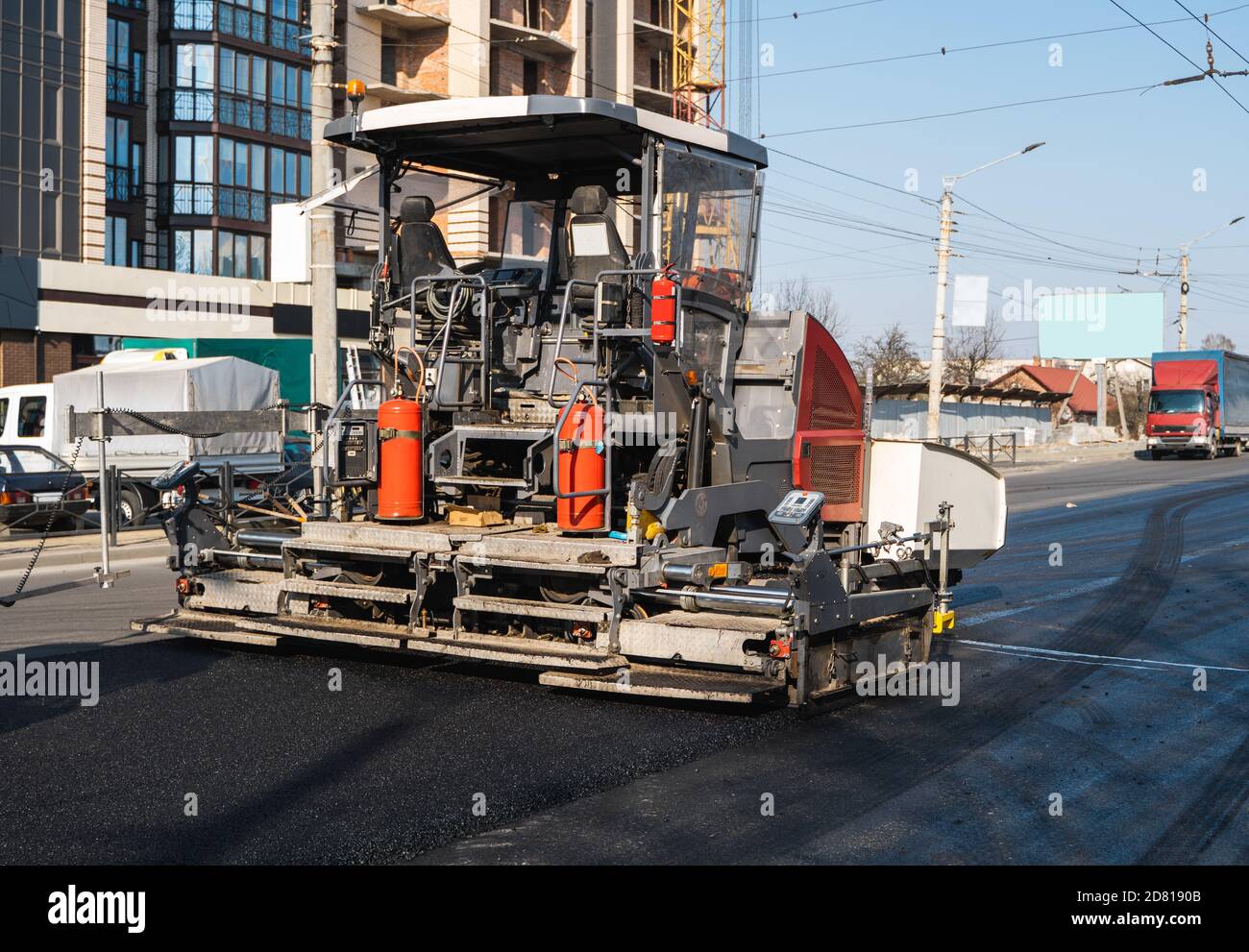 Industrial asphalt paver machine laying fresh asphalt on road ...