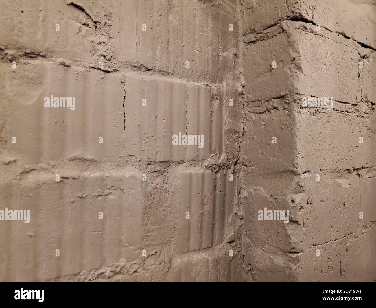 Brown grey rough structure of old cracked brick wall corner closeup ...