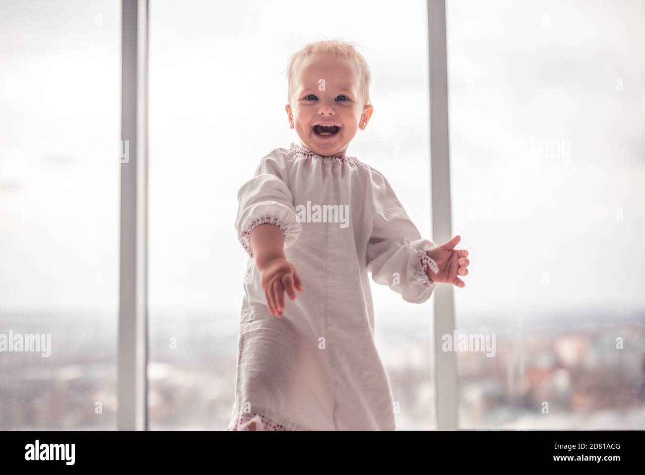 Cute happy baby is laughing fearless and freely with her new teeth ...