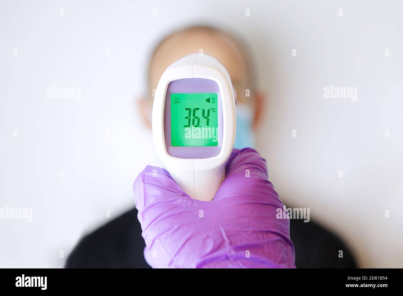 Hand holding a digital thermometer measuring a man temperature Stock ...