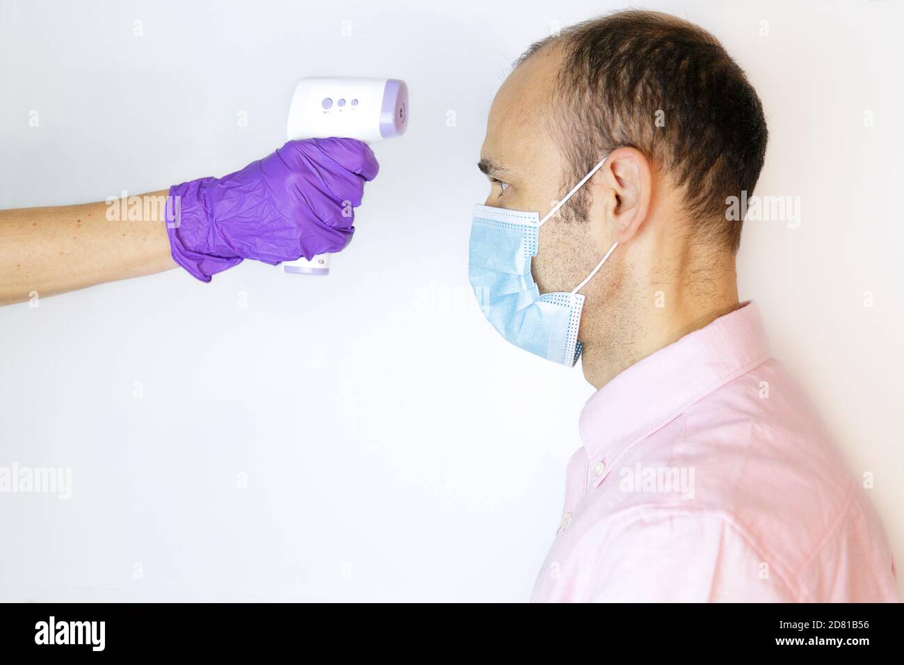 Hand holding a digital thermometer measuring a man temperature Stock ...