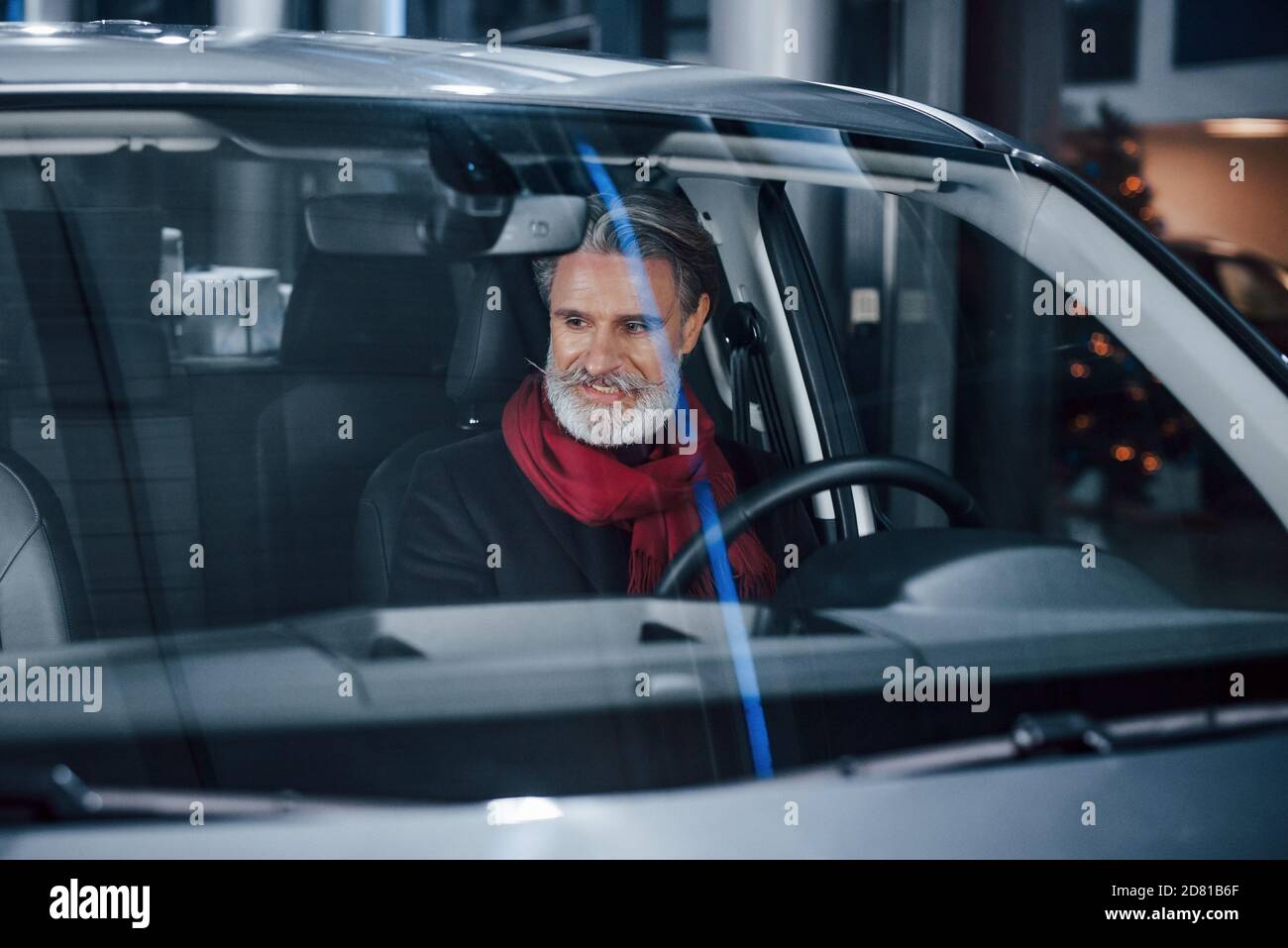 Modern stylish senior man with grey hair and mustache is in the modern ...