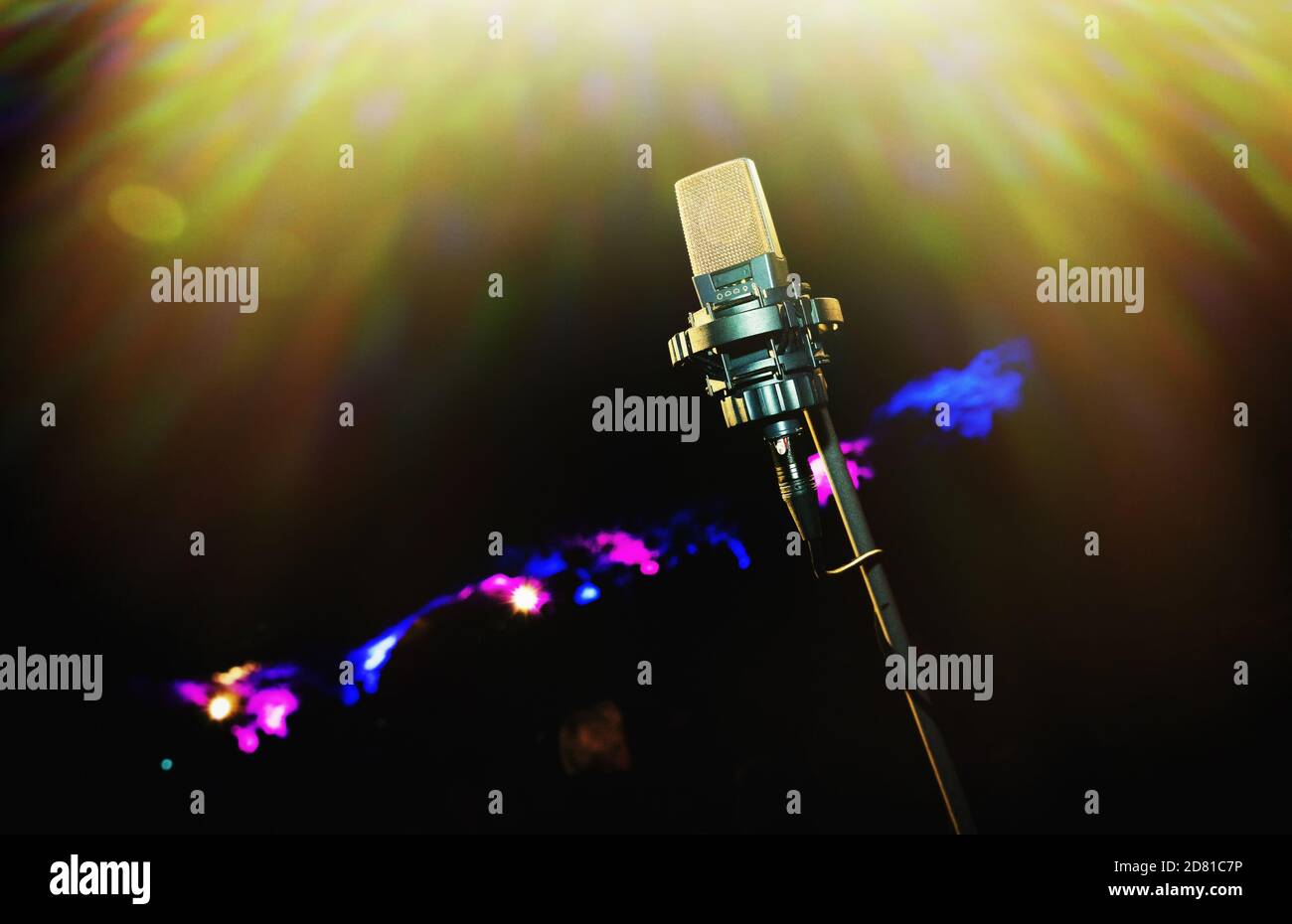 Microphone with golden rays of light. Retro microphone. A microphone on ...