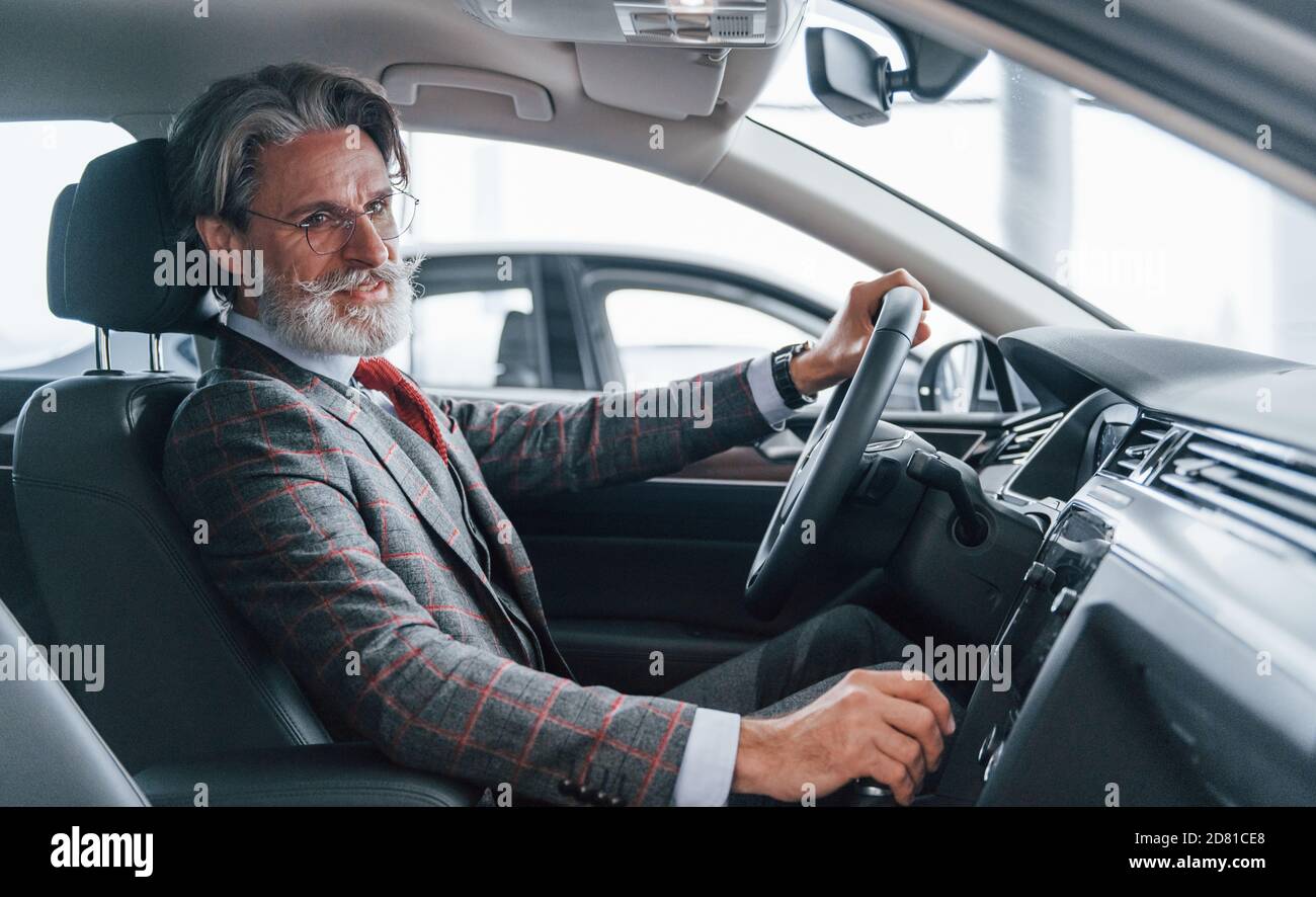 Modern stylish senior man with grey hair and mustache is in the modern ...