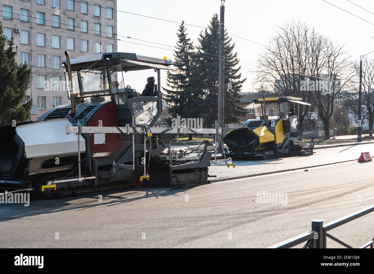 Industrial asphalt paver machine laying fresh asphalt on road ...