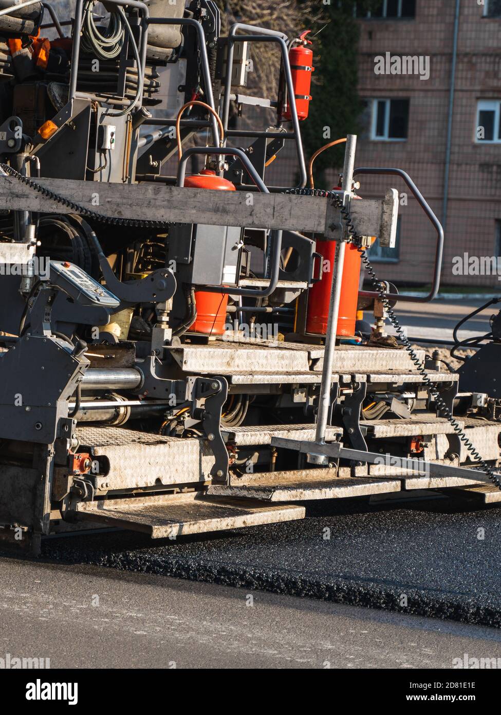 Industrial asphalt paver machine laying fresh asphalt on road ...