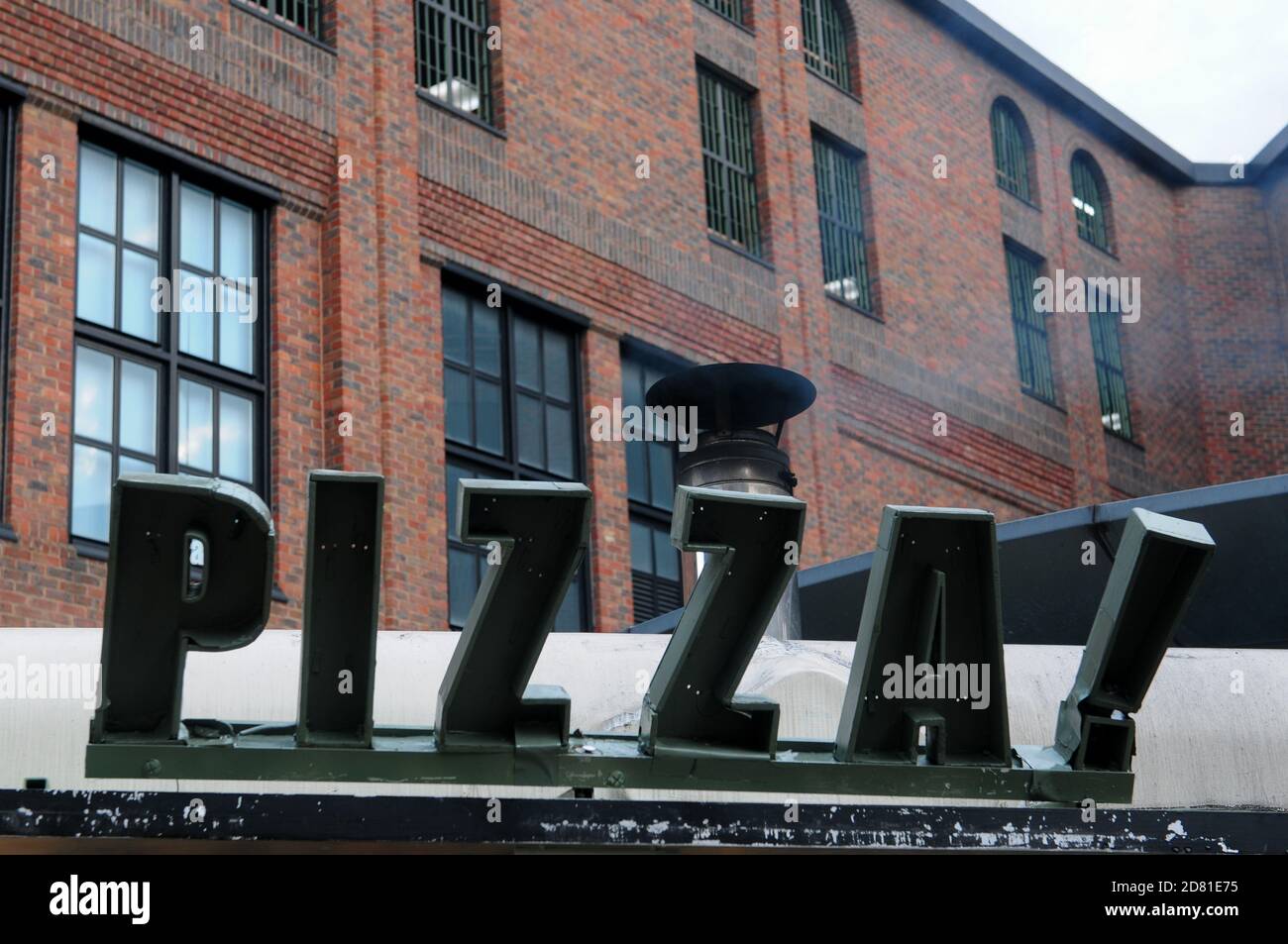 Pizza sign on top of street food truck with smoke from the pizza oven ...