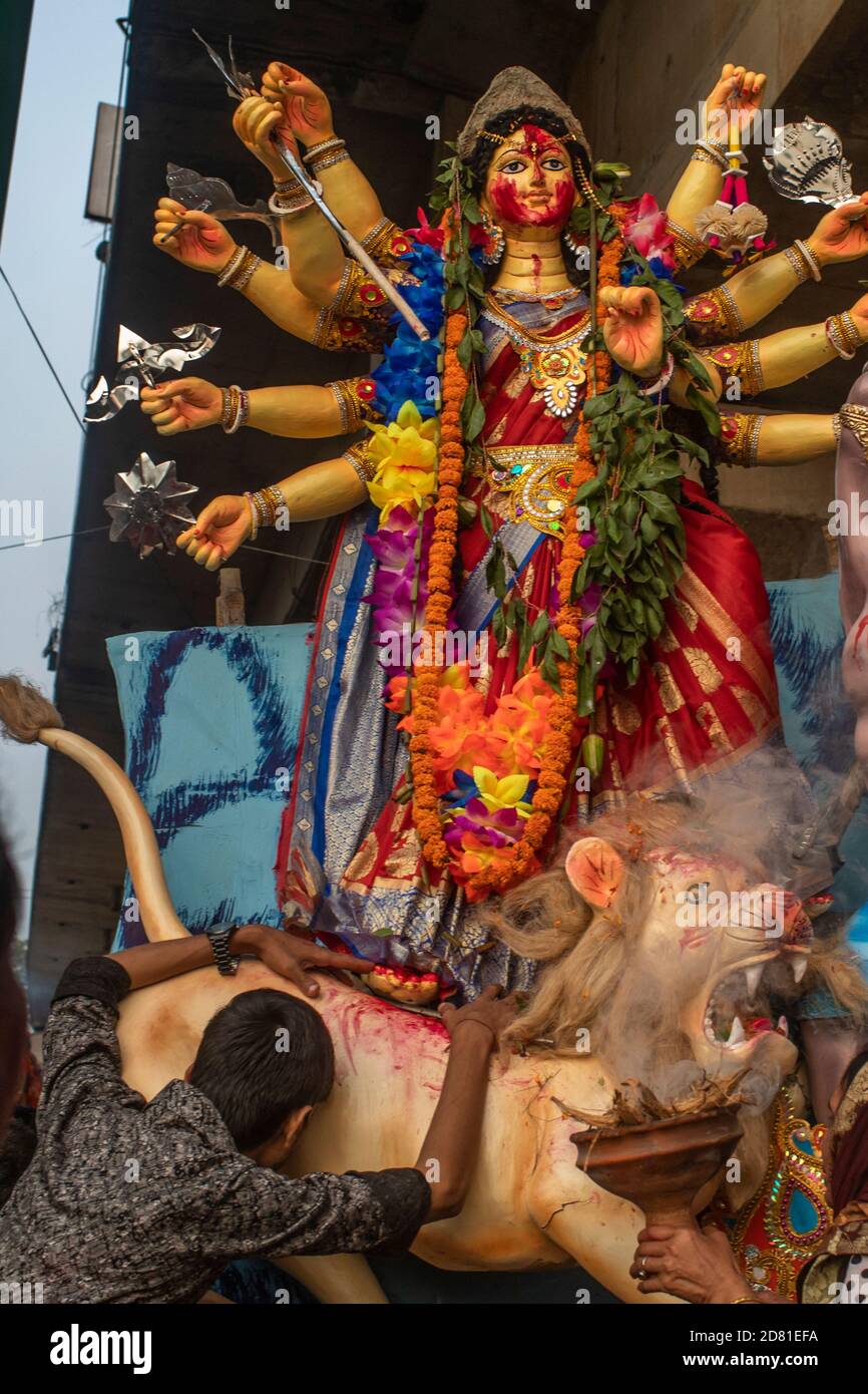 A devotees bows in worship of the goddess Durga during the final day of ...