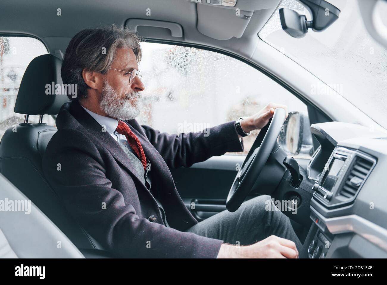 Modern stylish senior man with grey hair and mustache is in the modern ...