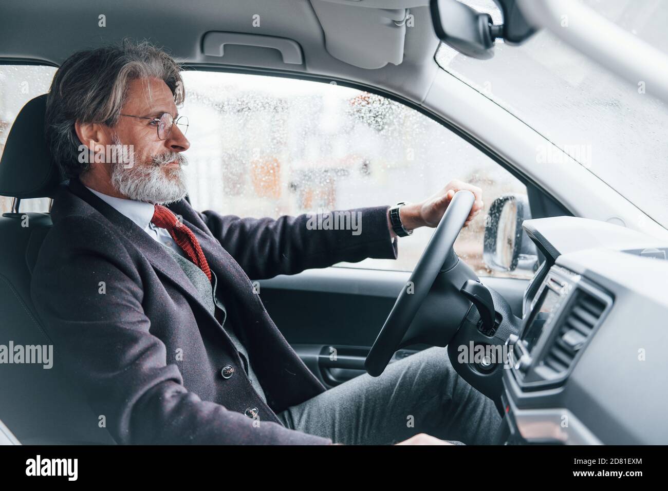 Modern stylish senior man with grey hair and mustache is in the modern ...