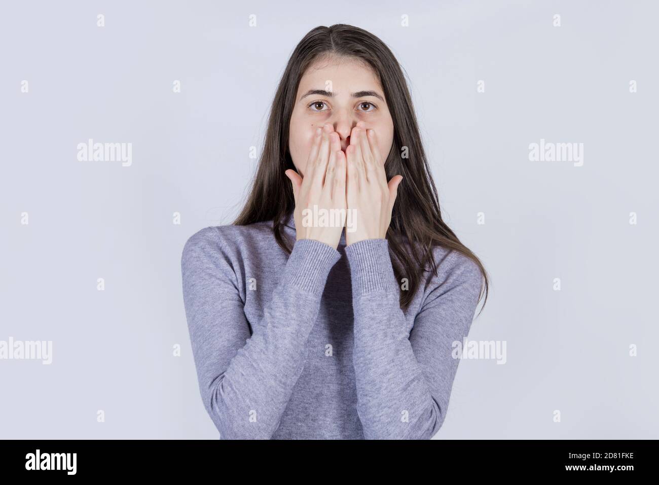 Young girl positively surprised with hands on her cheek. Beautiful ...