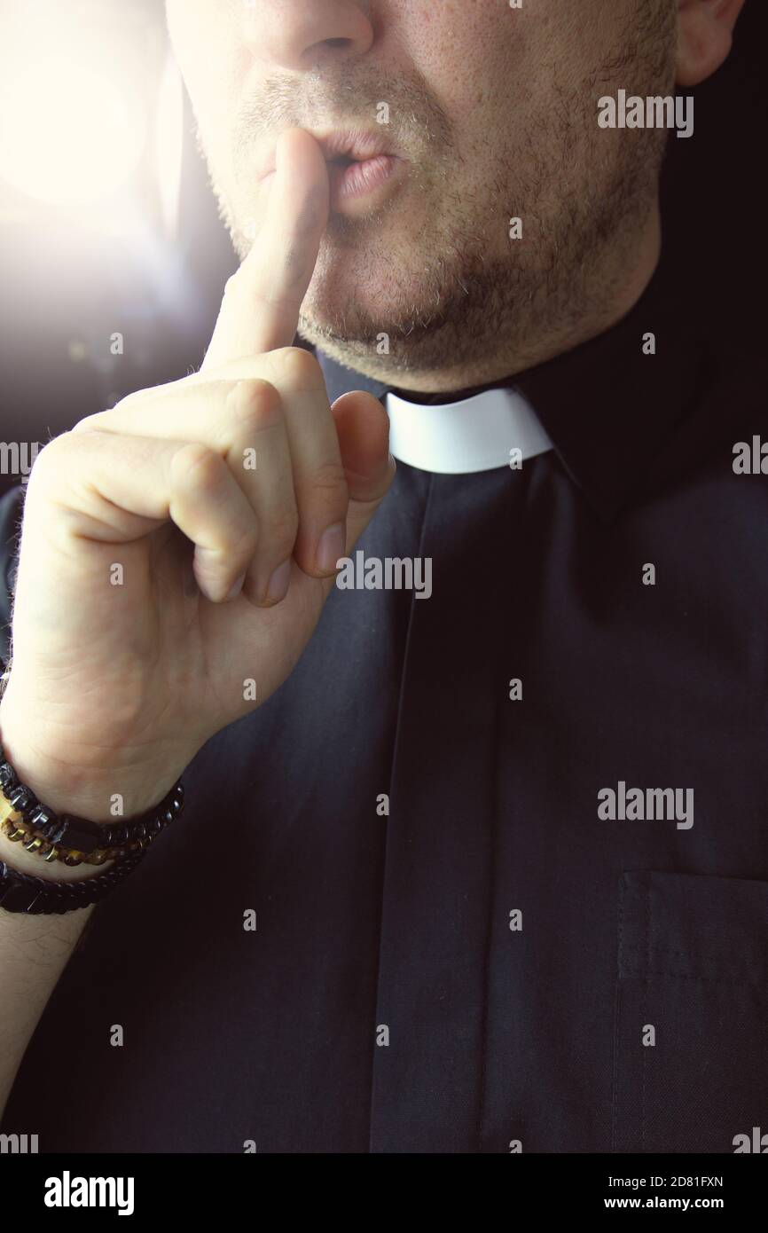 priest in the cassock hides a secret Stock Photo - Alamy