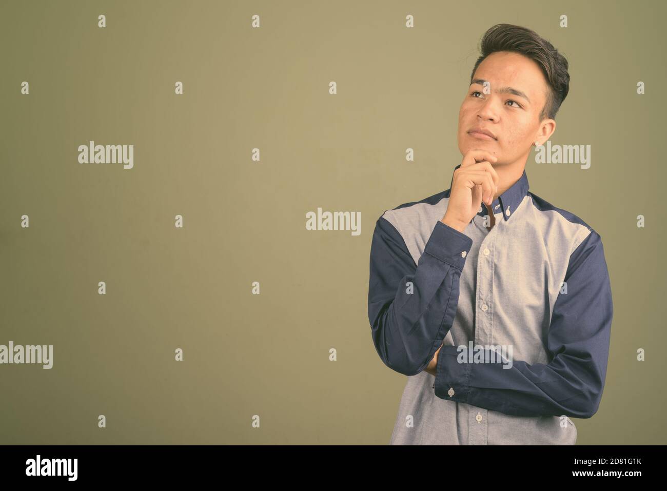 Young handsome Indian man looking smart against colored background ...