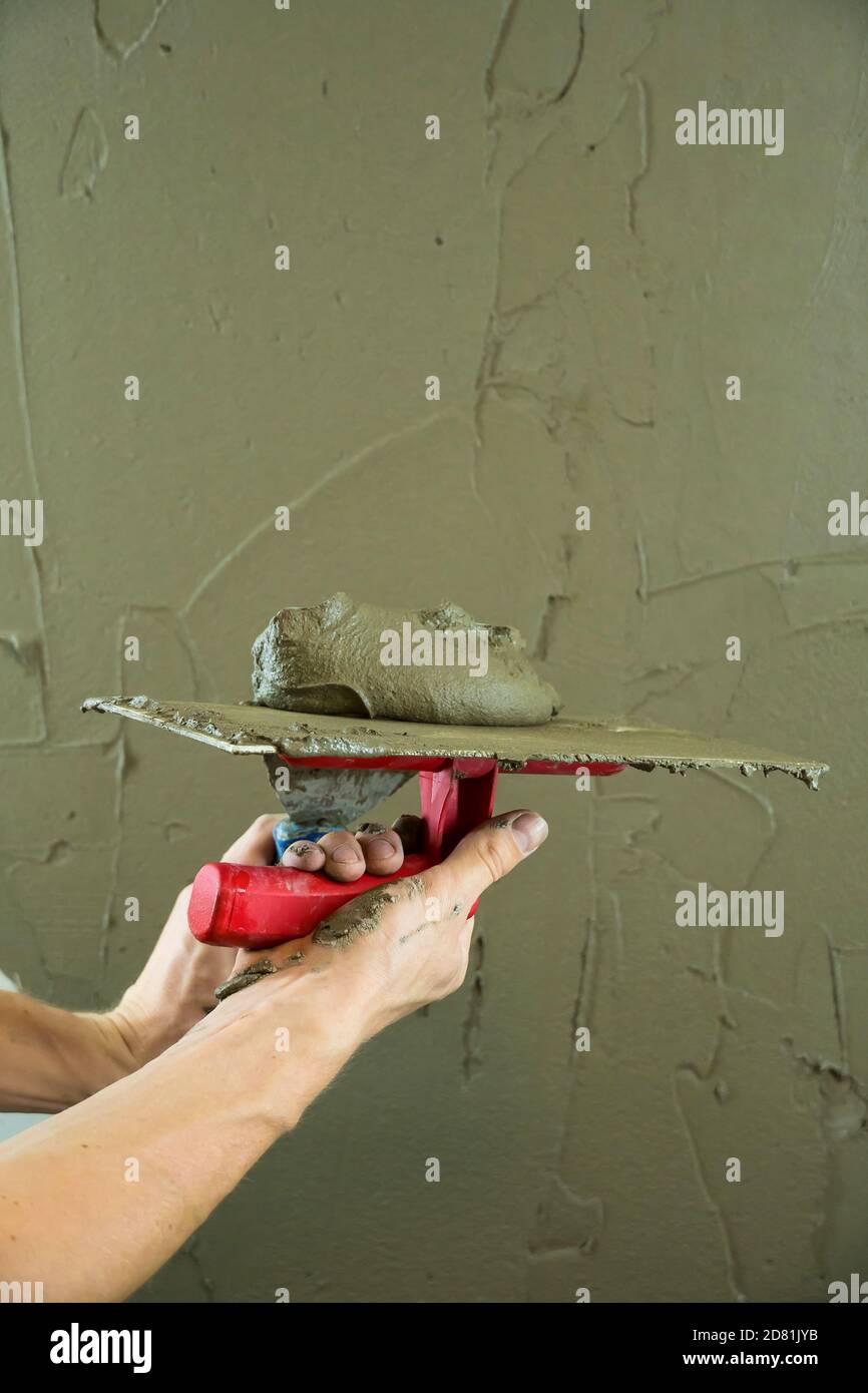 Worker plasters wall spatula hi-res stock photography and images - Alamy